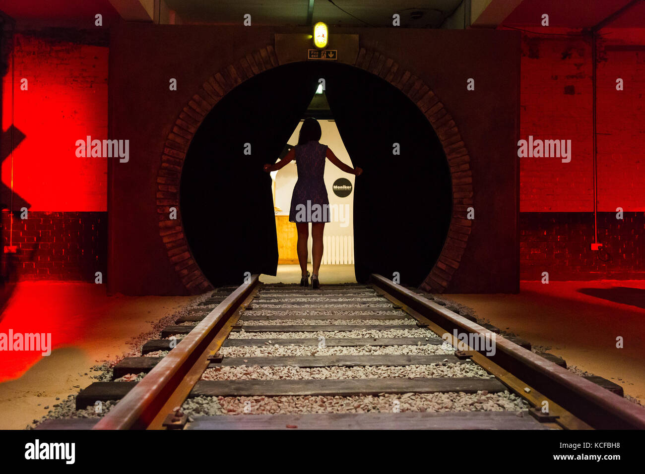 London, UK. 5th Oct, 2017. A woman stands on the train tracks ...