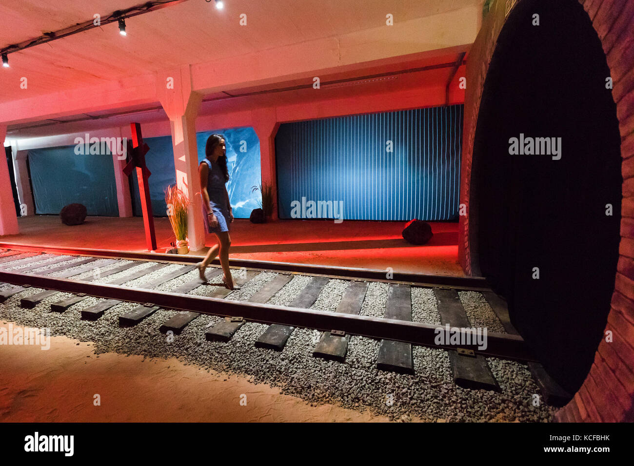 London, UK. 5th Oct, 2017. A woman walks along the train tracks ...