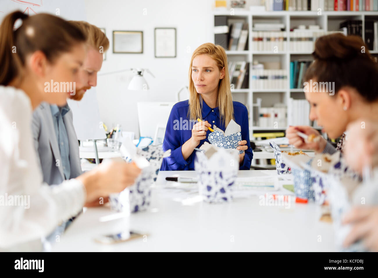 Business people eating in office Stock Photo - Alamy