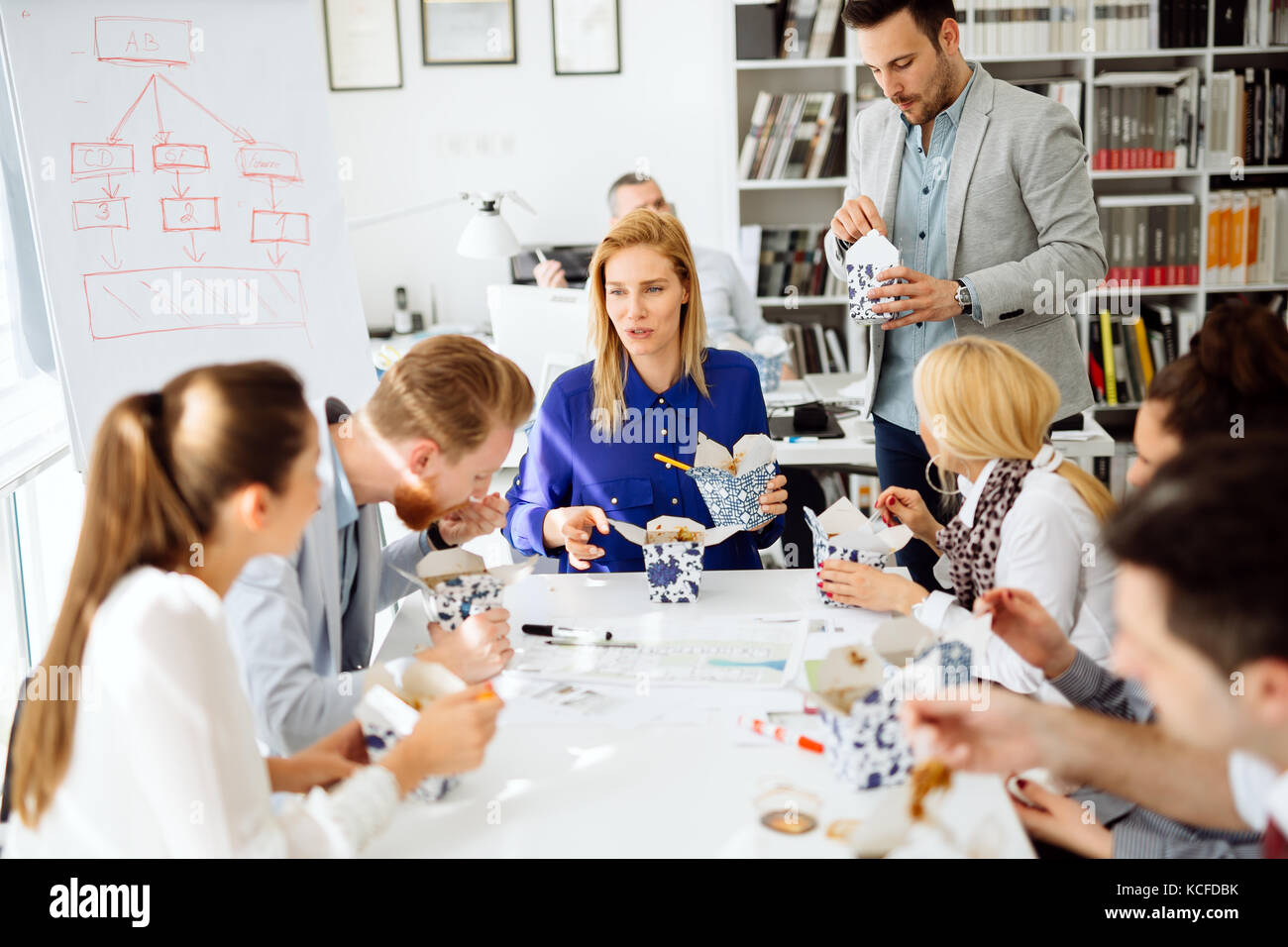 Business people eating in office Stock Photo - Alamy