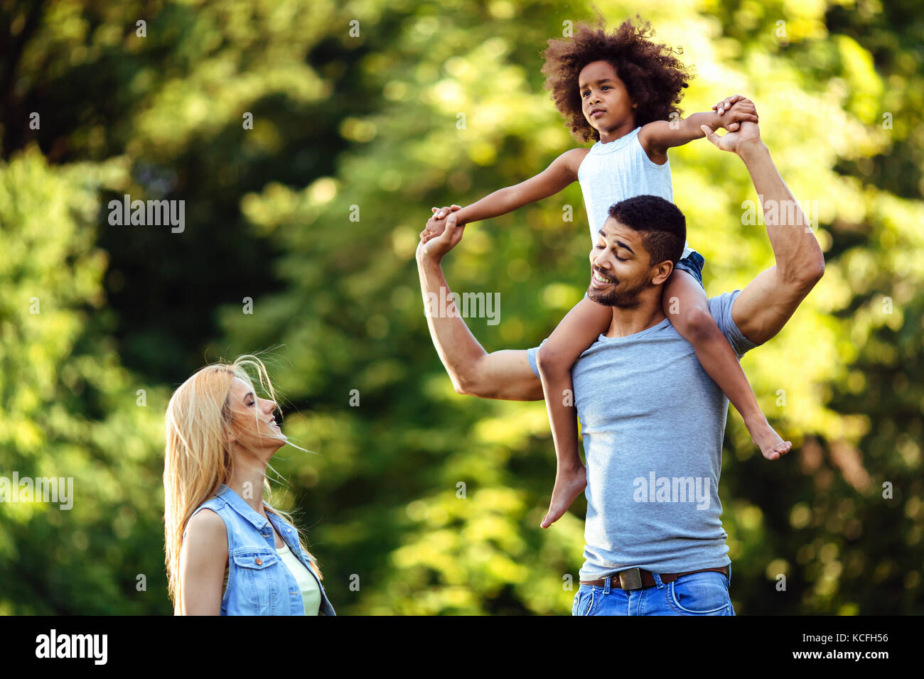 Picture of happy young couple spending time with their daughter Stock ...