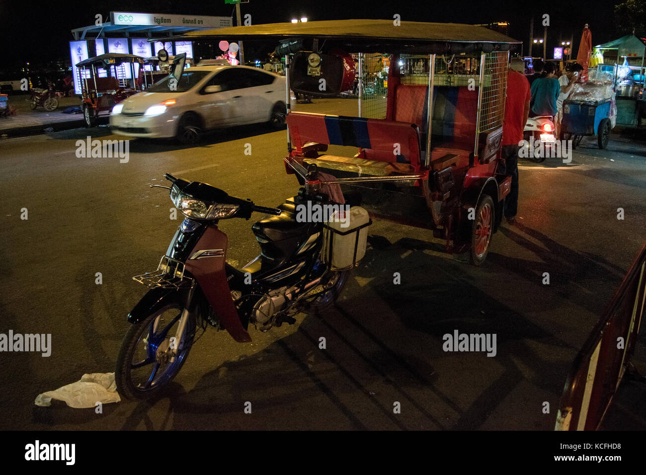 A pink tuk-tuk parked next to the Phnom Penh night market. Waiting for ...