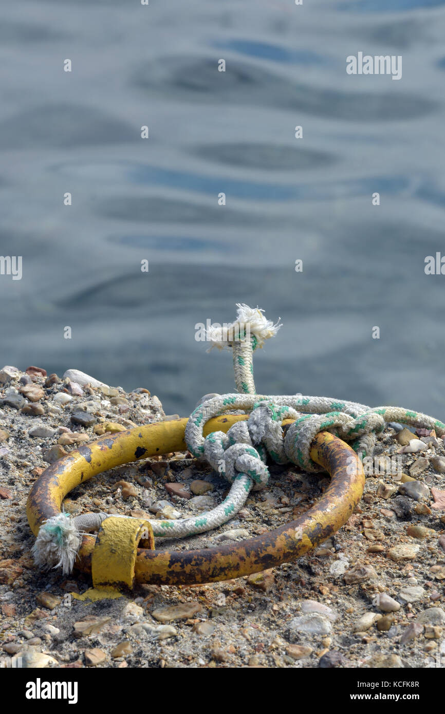 an iron ring with a rope attached for tying up ships and boats on the ...