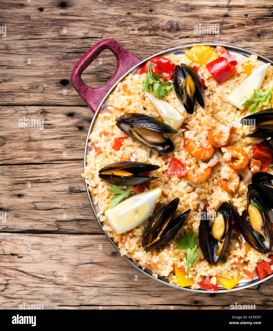 vegetable paella with seafood on wooden background Stock Photo - Alamy