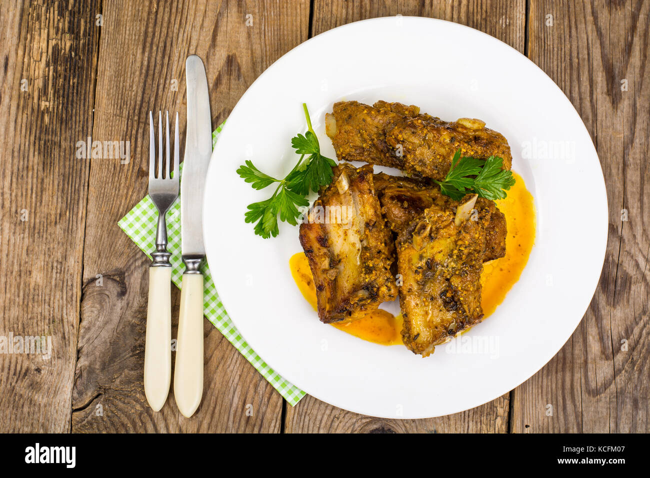 Spicy meat ribs in mustard sauce on wooden table Stock Photo - Alamy
