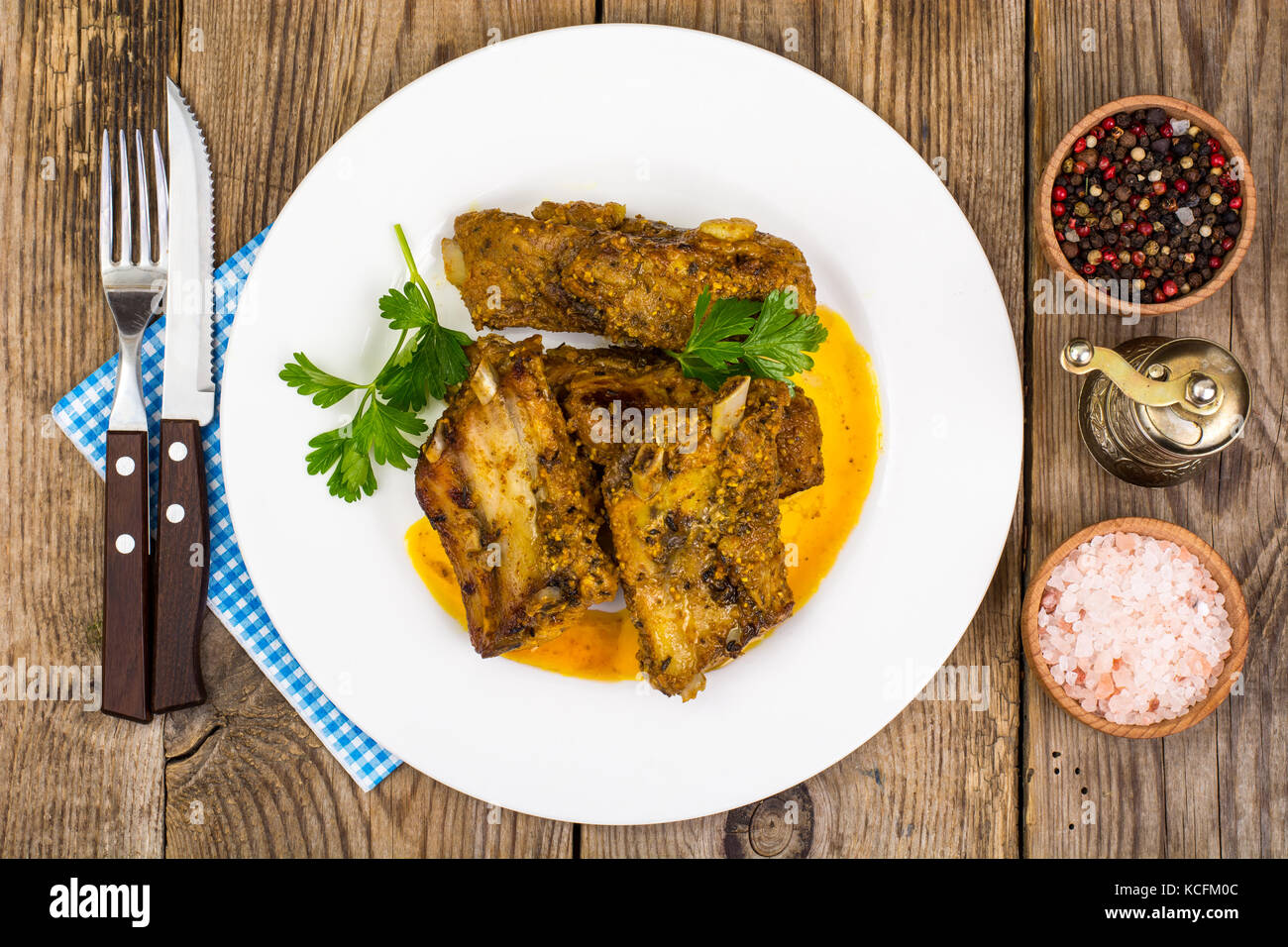 Spicy meat ribs in mustard sauce on wooden table Stock Photo - Alamy