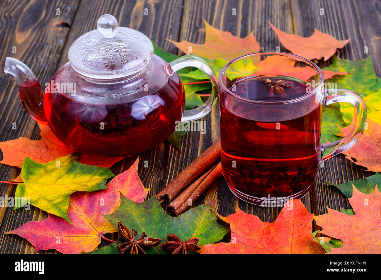 Red tea with karkade, autumn leaves on wooden table Stock Photo - Alamy