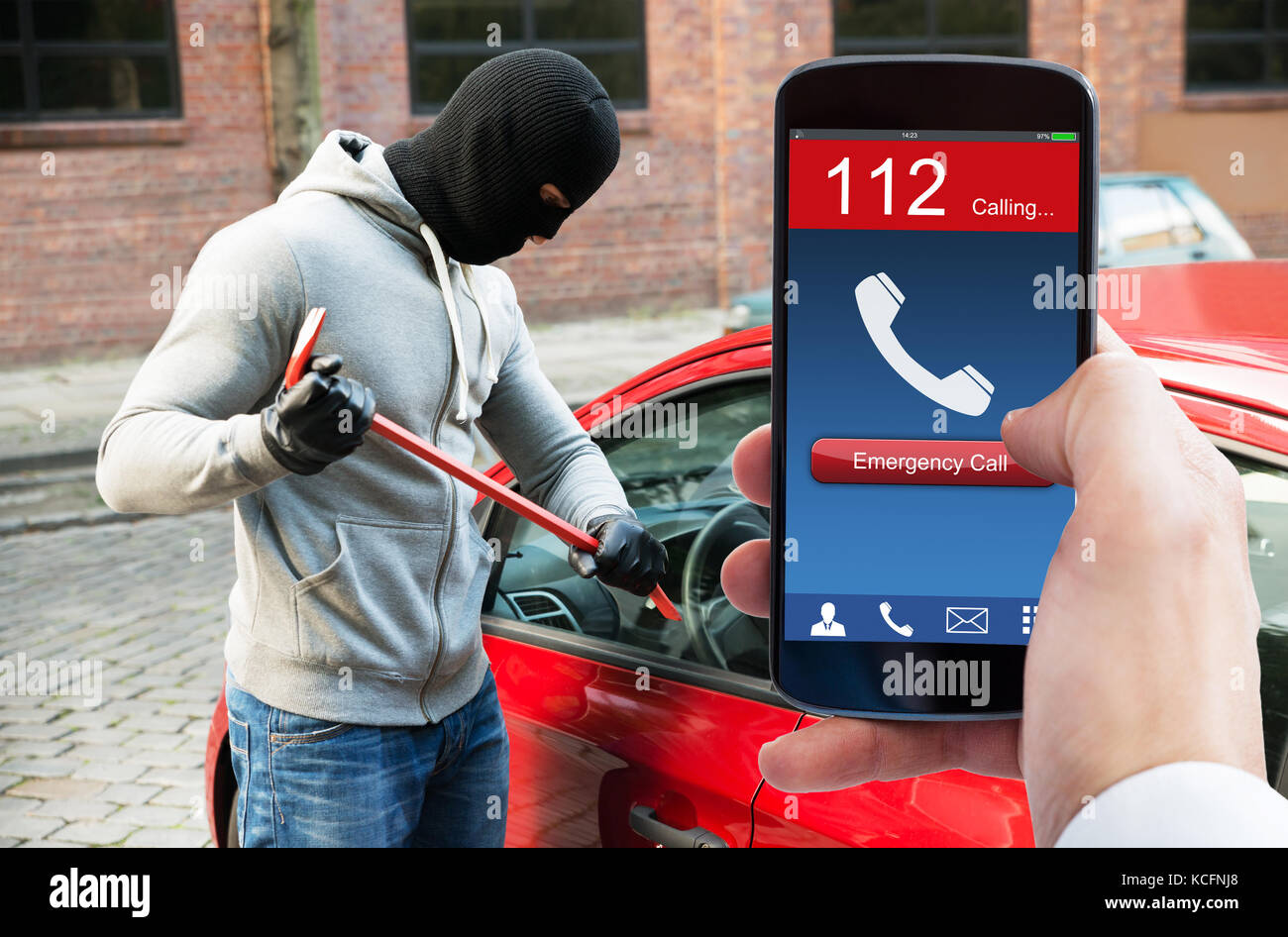 Person's Hand With Emergency Call On Mobile Phone While Burglar Opening ...