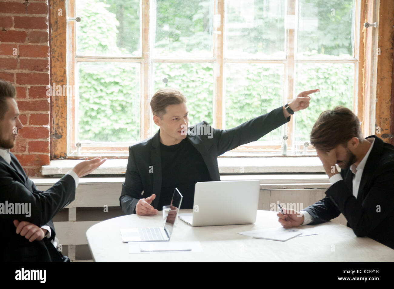 Strict boss, telling upset male employee to leave meeting room during ...