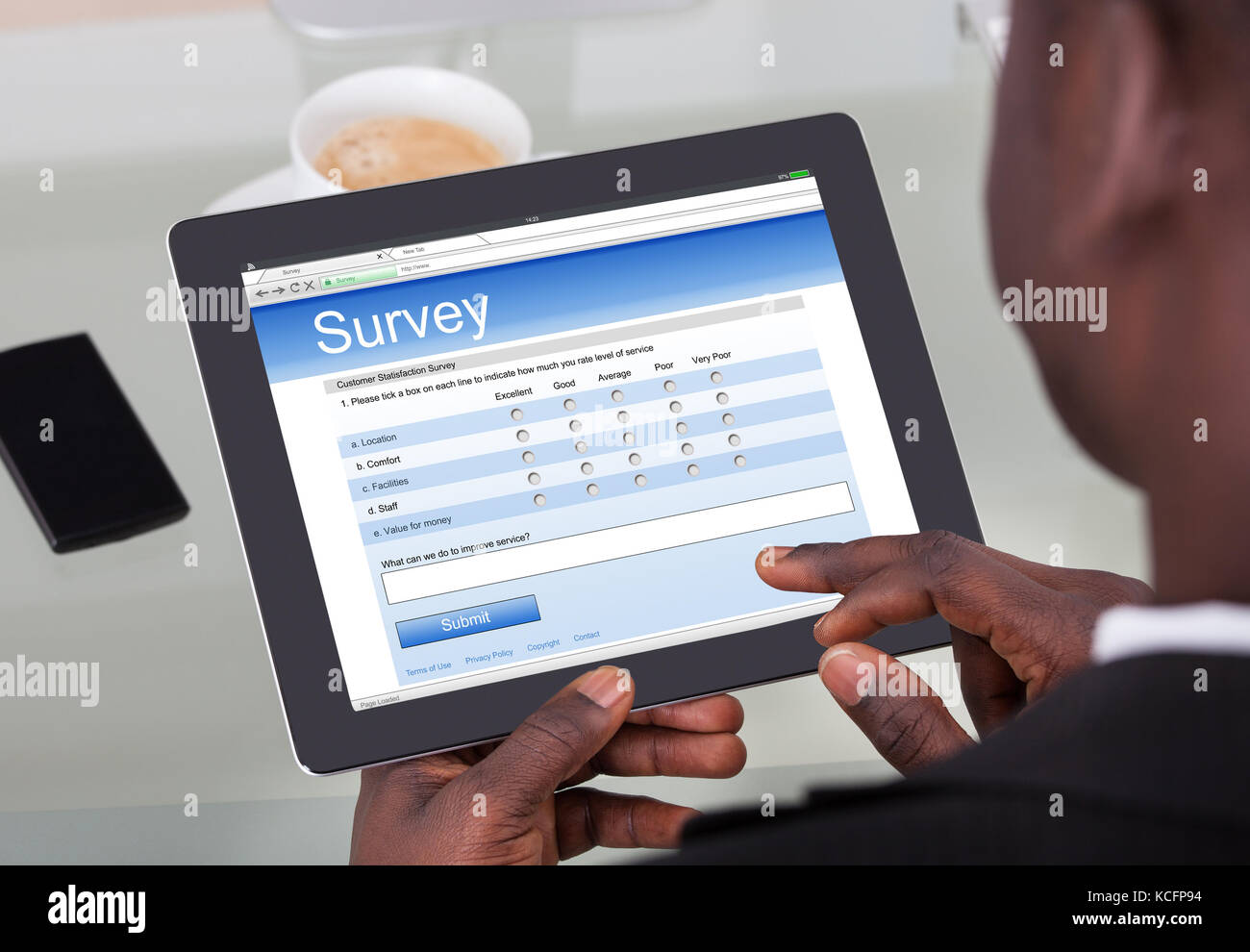 Close-up Of A Businessperson Filling Survey Form On His Digital Tablet ...