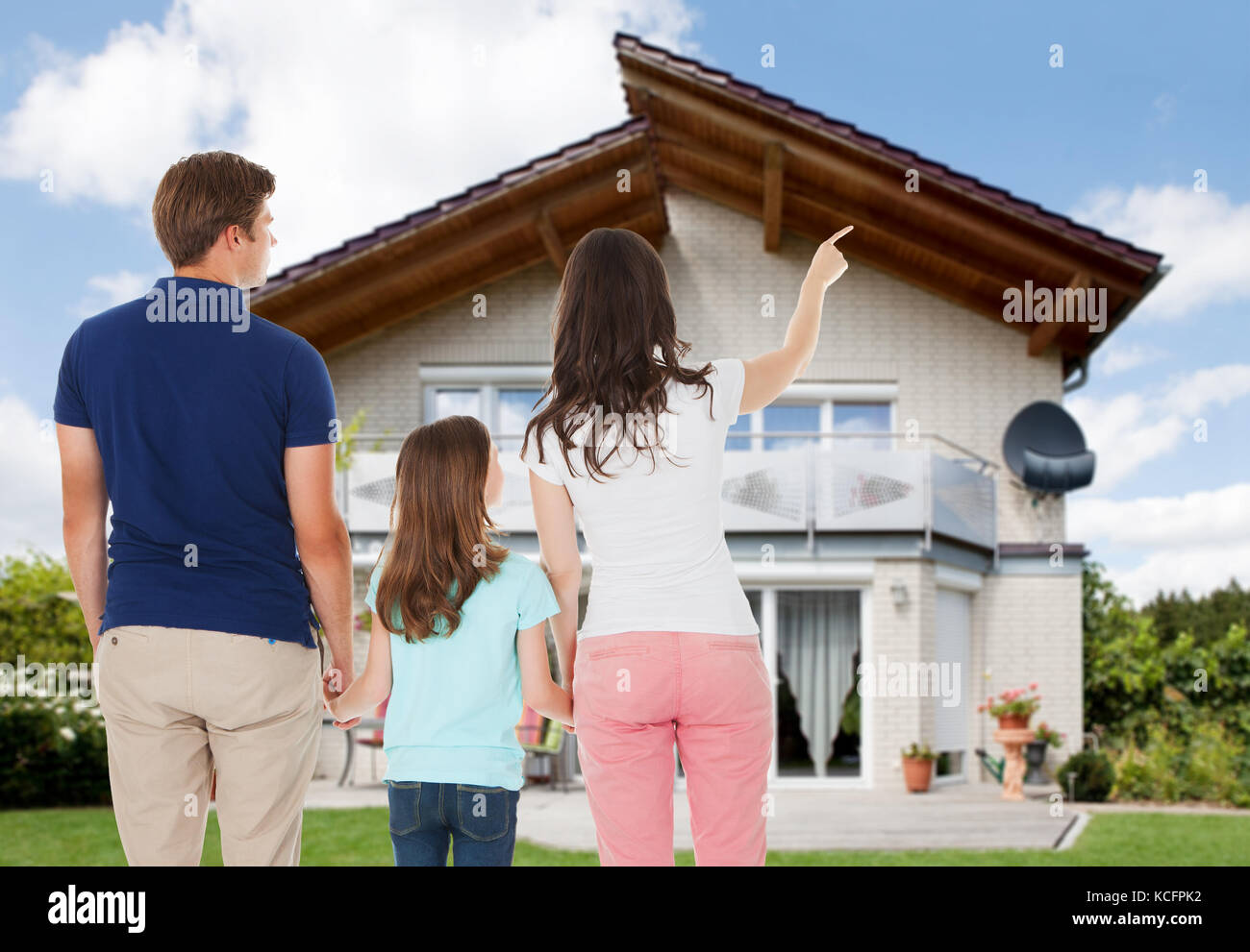 Rear View Of A Family Standing In Front Of House Stock Photo - Alamy