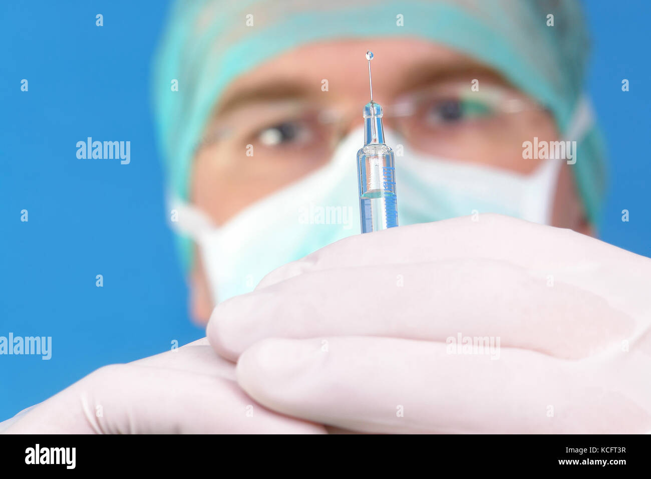 Closeup of surgeon preparing syringe for injection - shallow depth of ...