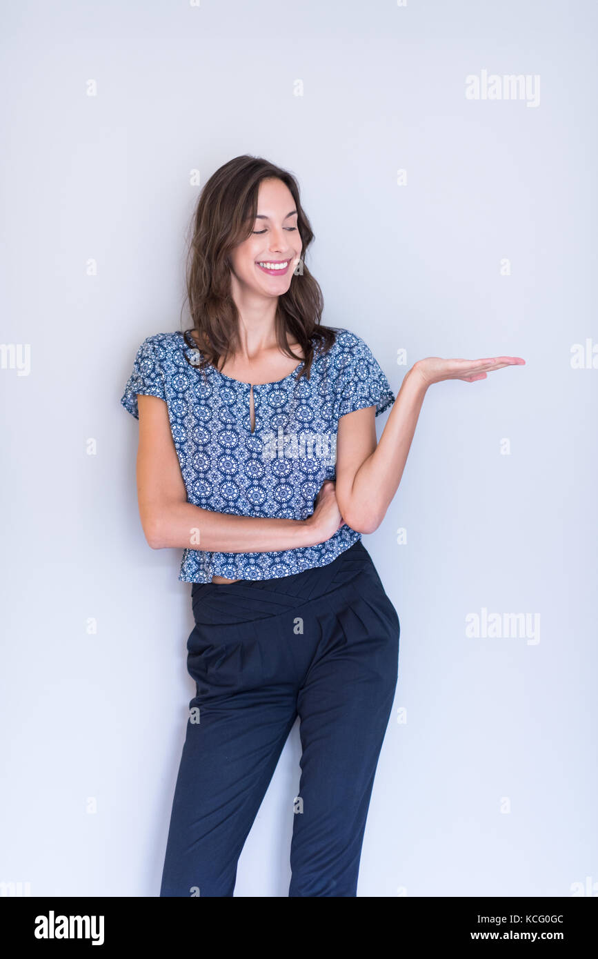 Young beautiful woman presenting your product, isolated over white ...