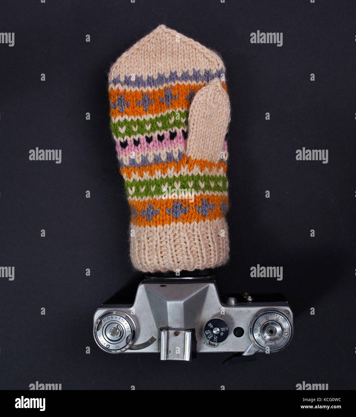 A knitted mitten is worn on a vintage camera lens. Top view Stock Photo ...