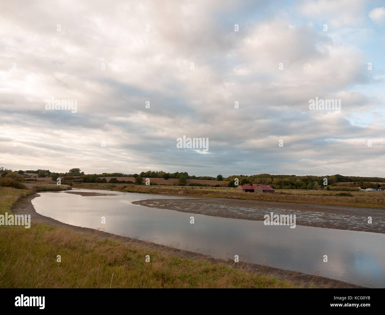 lake river through countryside with farm house roof agriculture scene ...