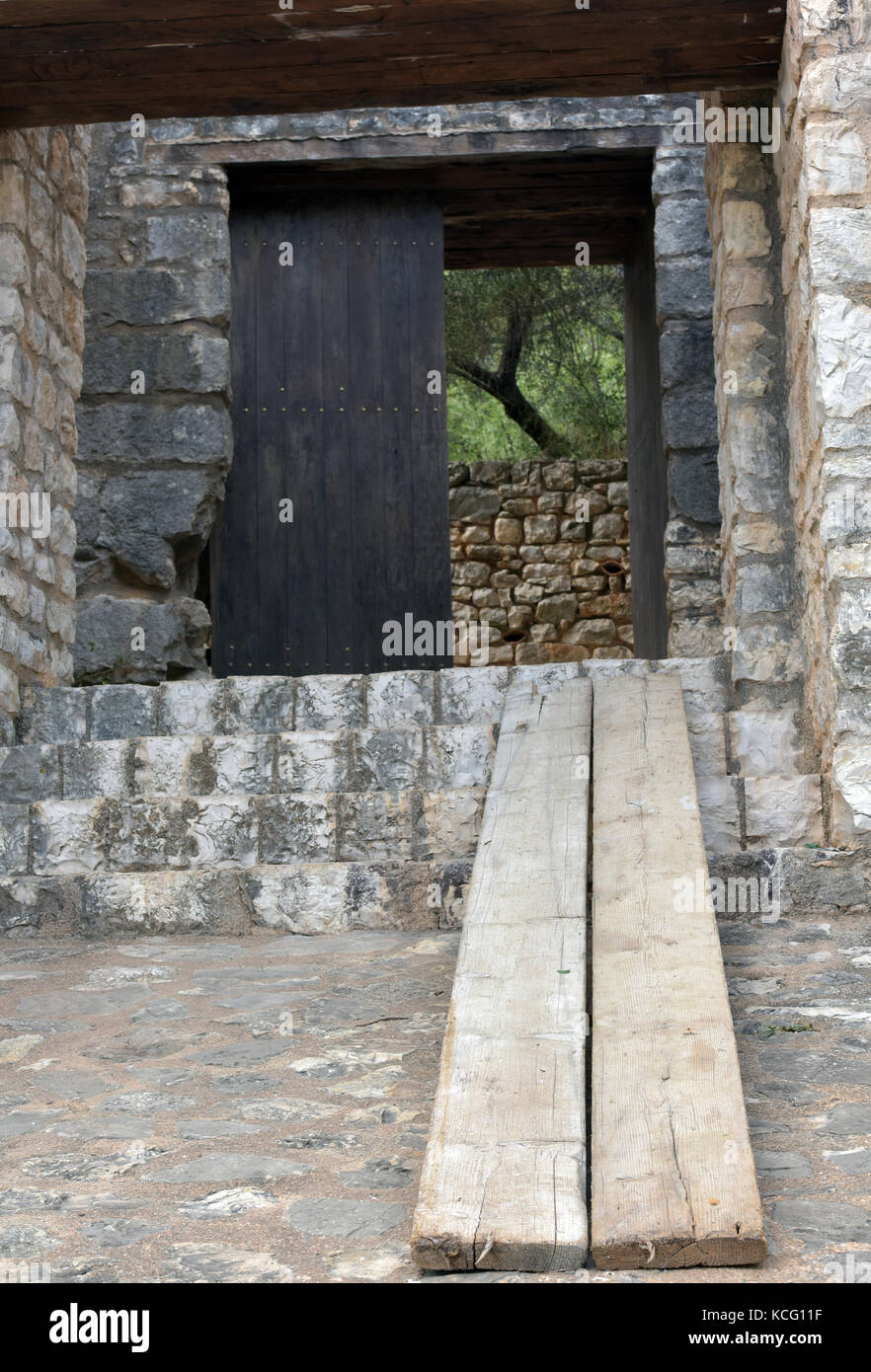 Some scaffold boards or planks being used as a ramp for tools, plant ...