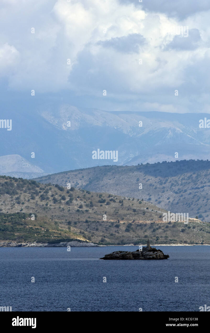 a small island of rocks in the sea between the greek island of corfu ...