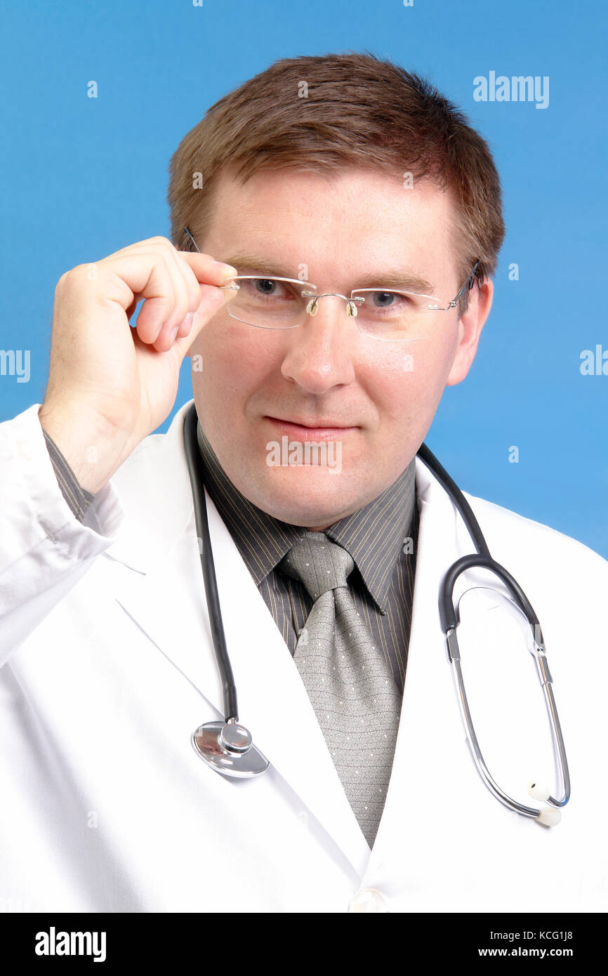 Portrait of young doctor with stethoscope over blue background Stock ...