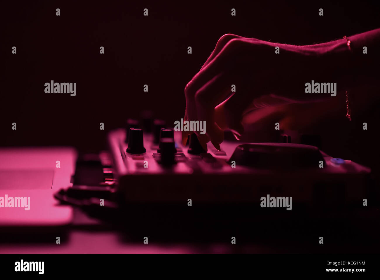 DJ mixer disco illuminated by searchlights Stock Photo - Alamy