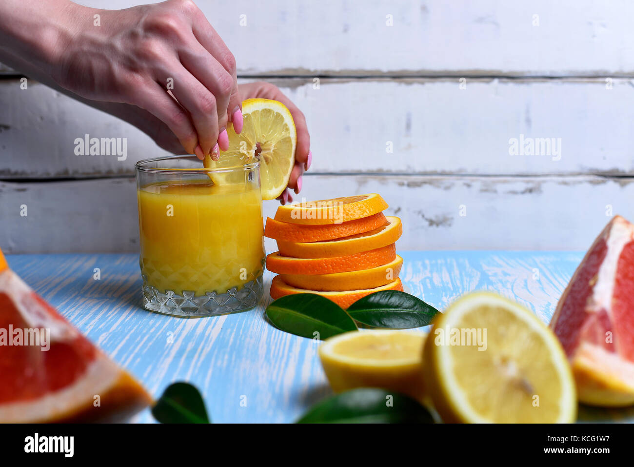 The orange in the hands Stock Photo - Alamy