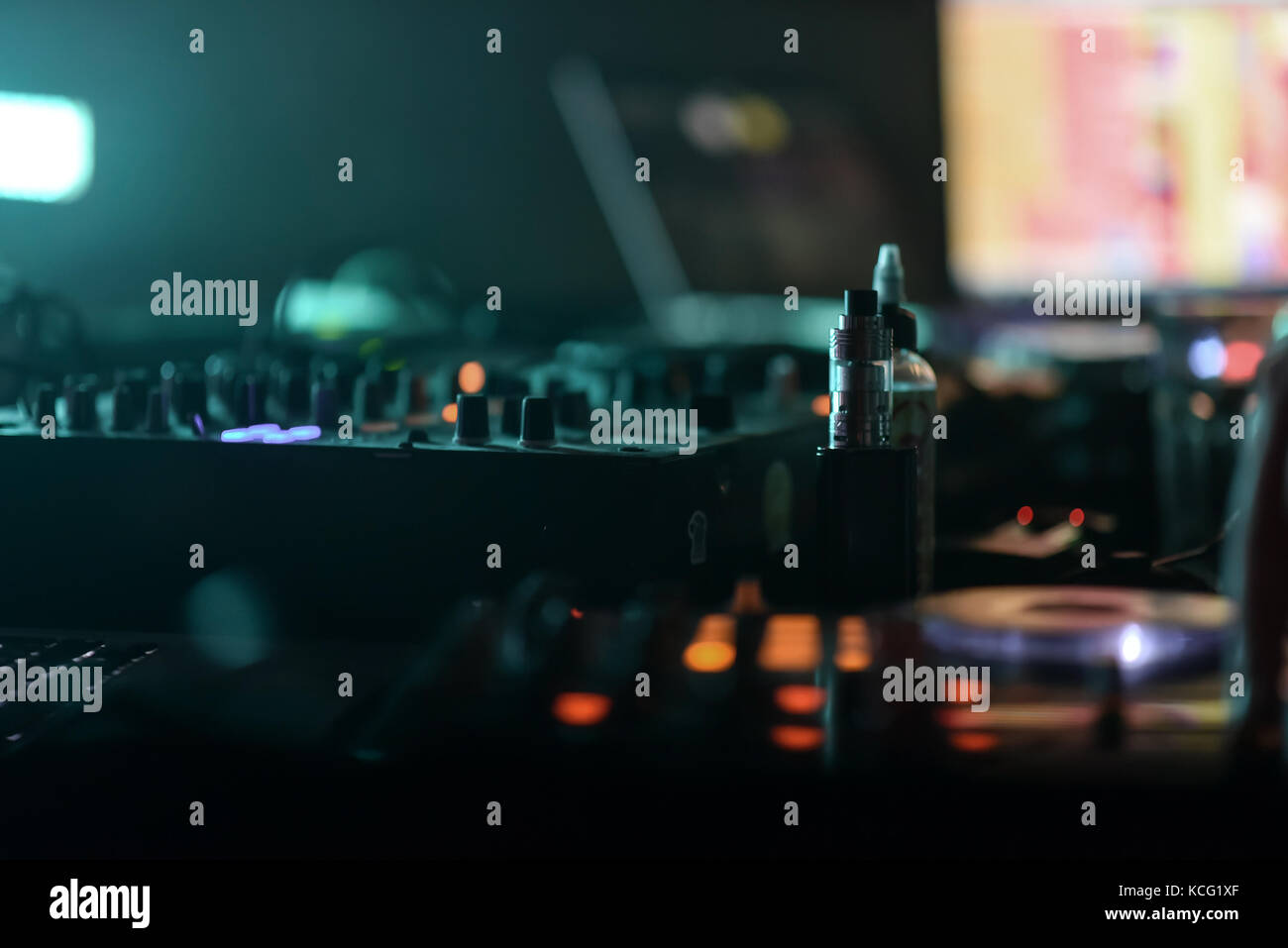DJ mixer disco illuminated by searchlights Stock Photo - Alamy
