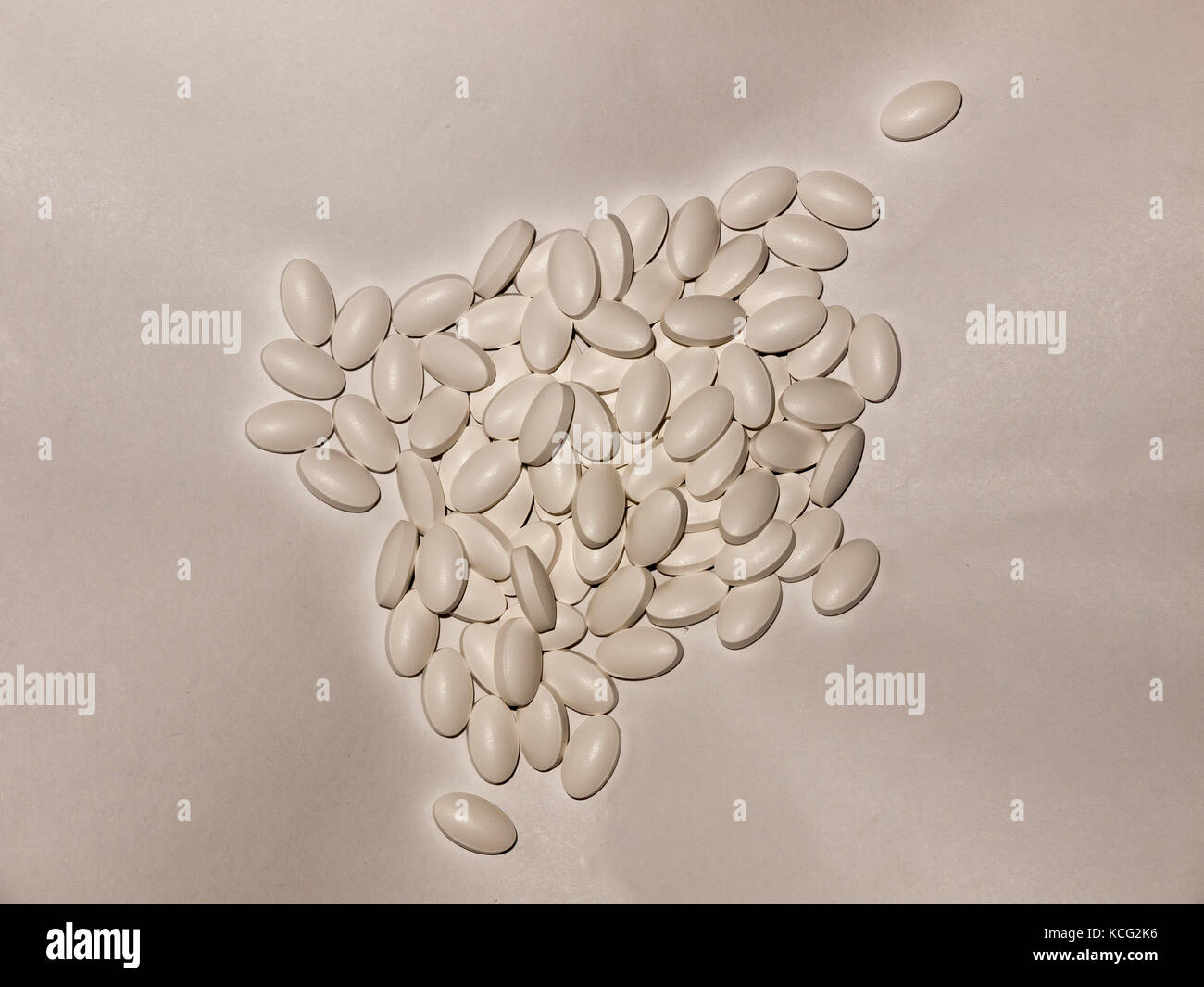 many white generic tablet pills on a white background; Essex; England ...