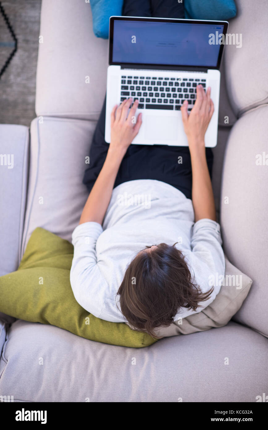 Young woman using her laptop computer in her luxury modern home top ...