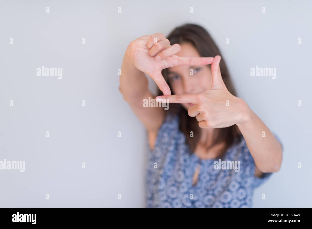 young happy woman showing framing hand gesture isolated on a white ...