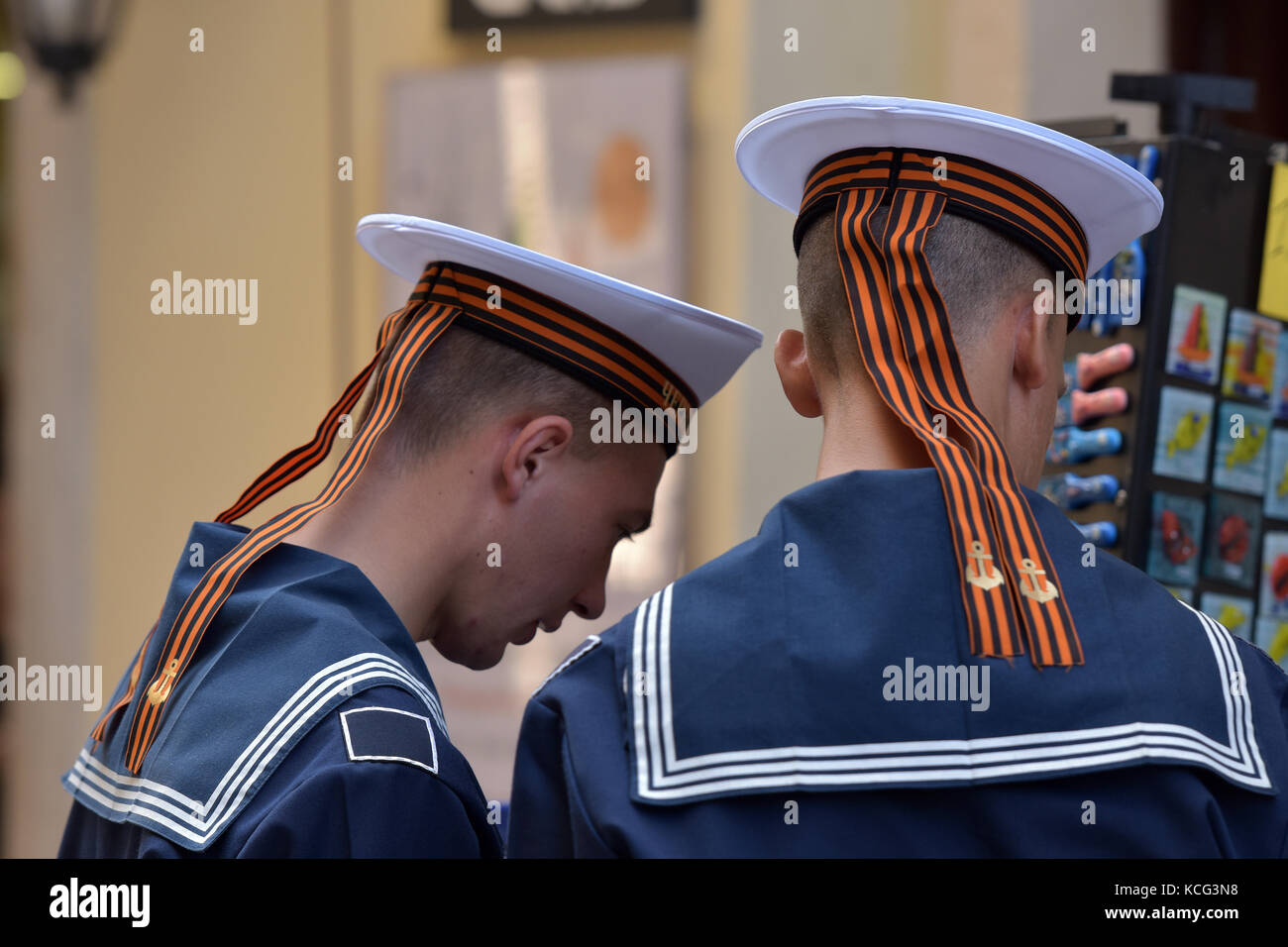 Some foreign greek sailors visiting corfu town looking at tourist ...