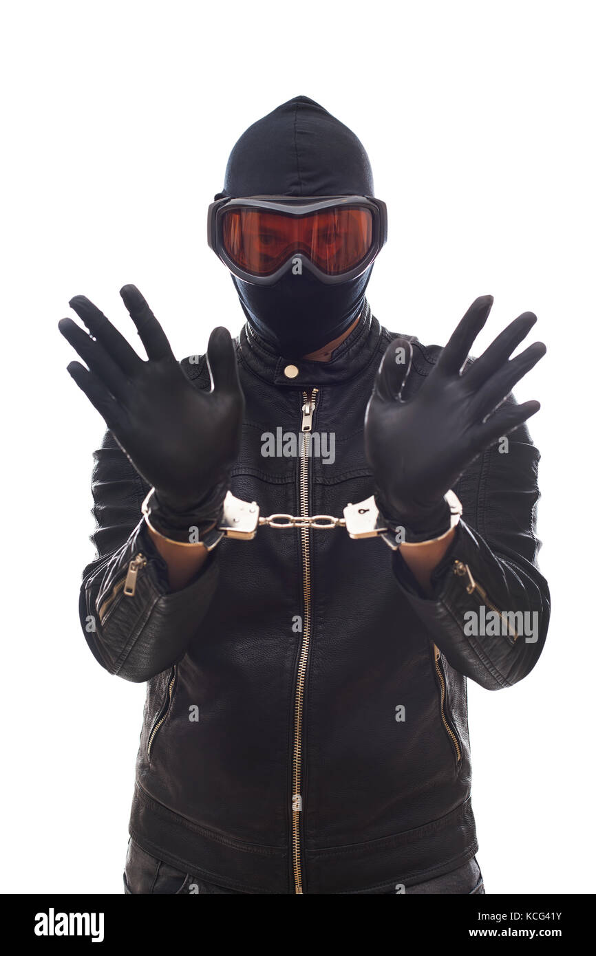 Dangerous criminal wearing black clothes and mask with handcuffs on ...