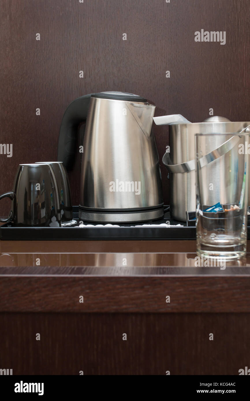 tea and coffee set for self-service on wood shelf in luxury hotel room ...