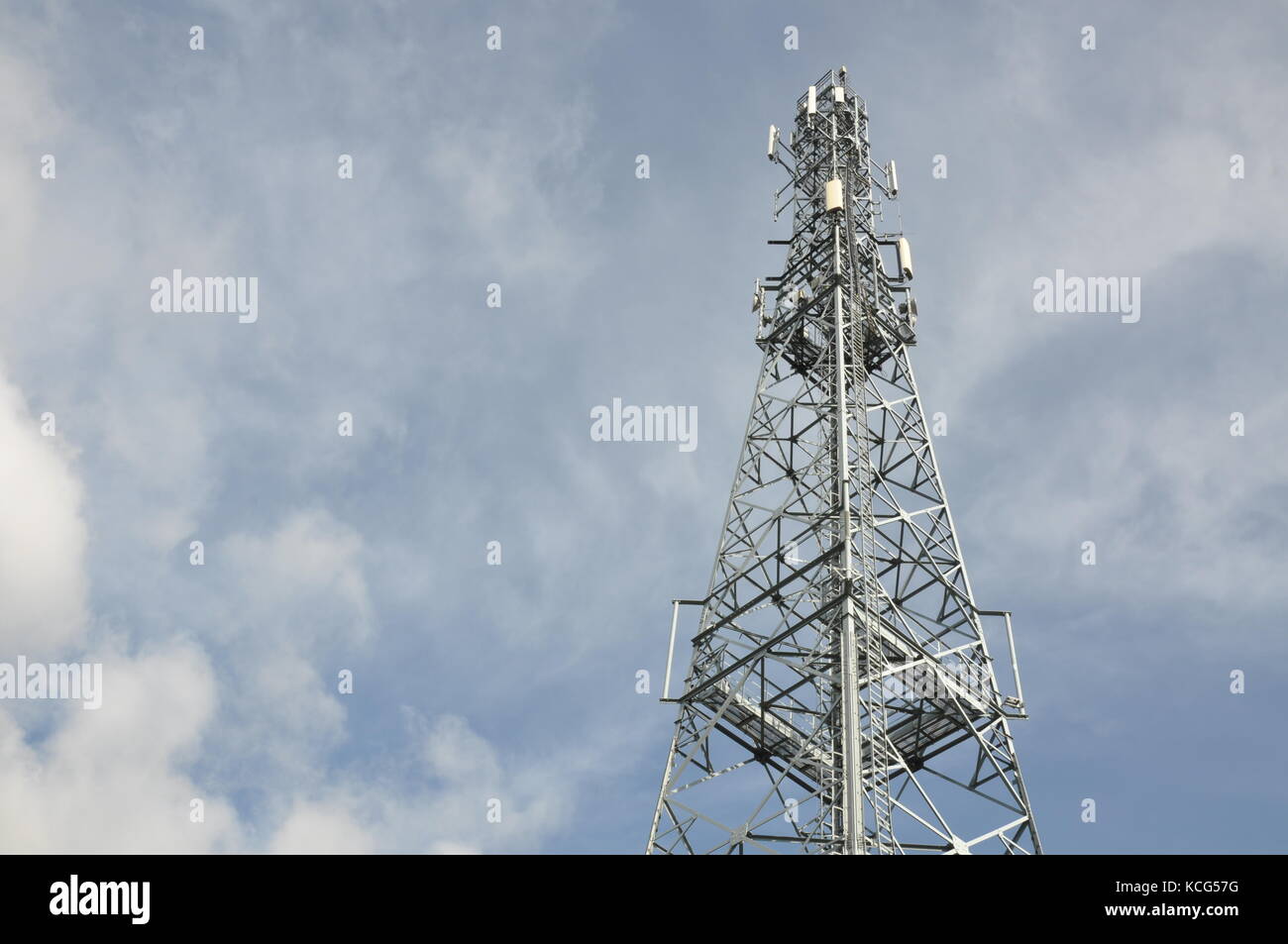 Telecommunication tower with blue and cloudy sky Stock Photo - Alamy