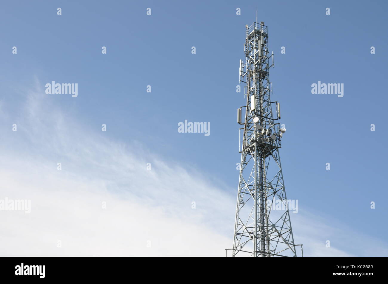 Telecommunication tower with blue and cloudy sky Stock Photo - Alamy