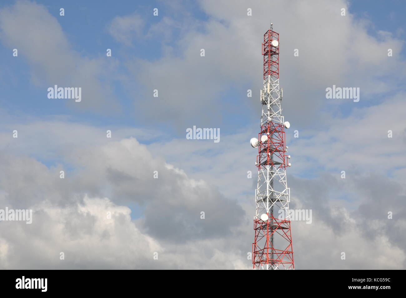 Telecommunication tower with blue and cloudy sky Stock Photo - Alamy