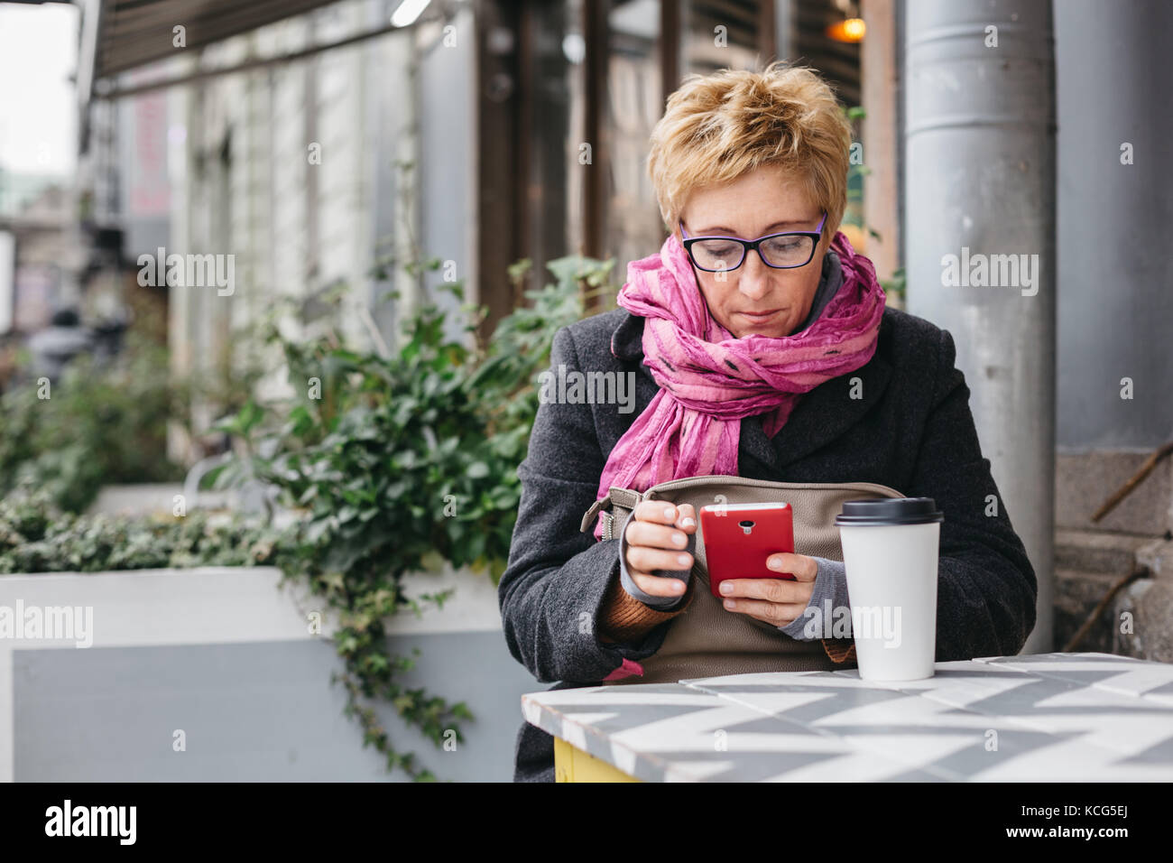 Adult woman surfing phone Stock Photo - Alamy