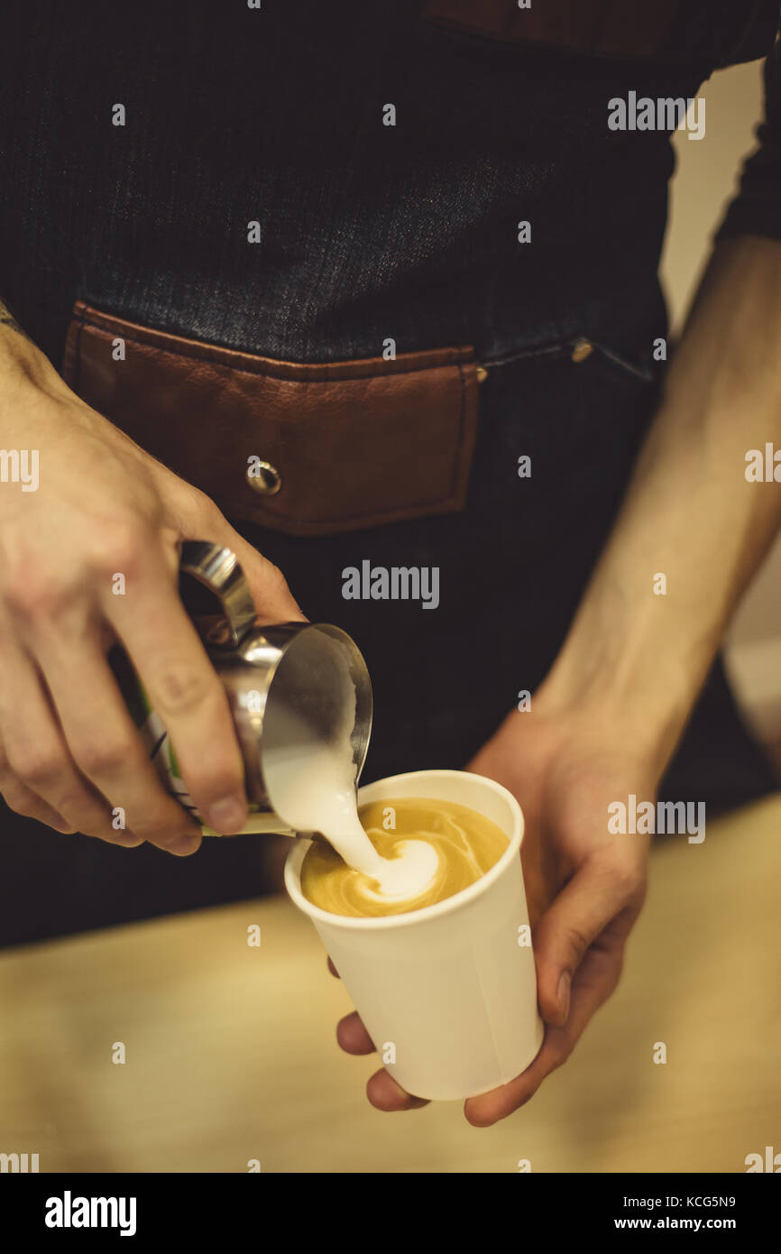 Bartender pouring coffee to cup Stock Photo - Alamy
