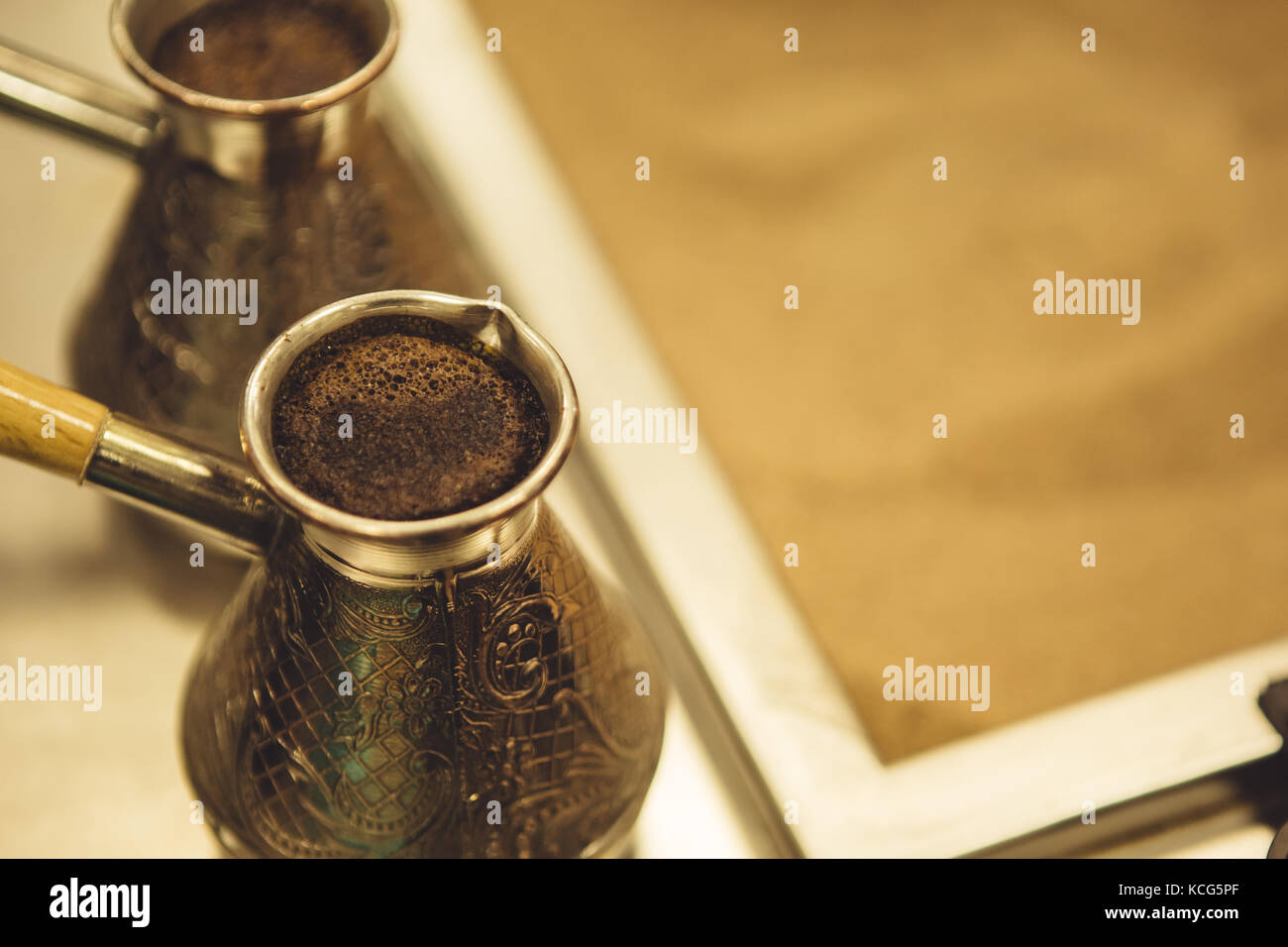 Jezve placed in sand Stock Photo - Alamy