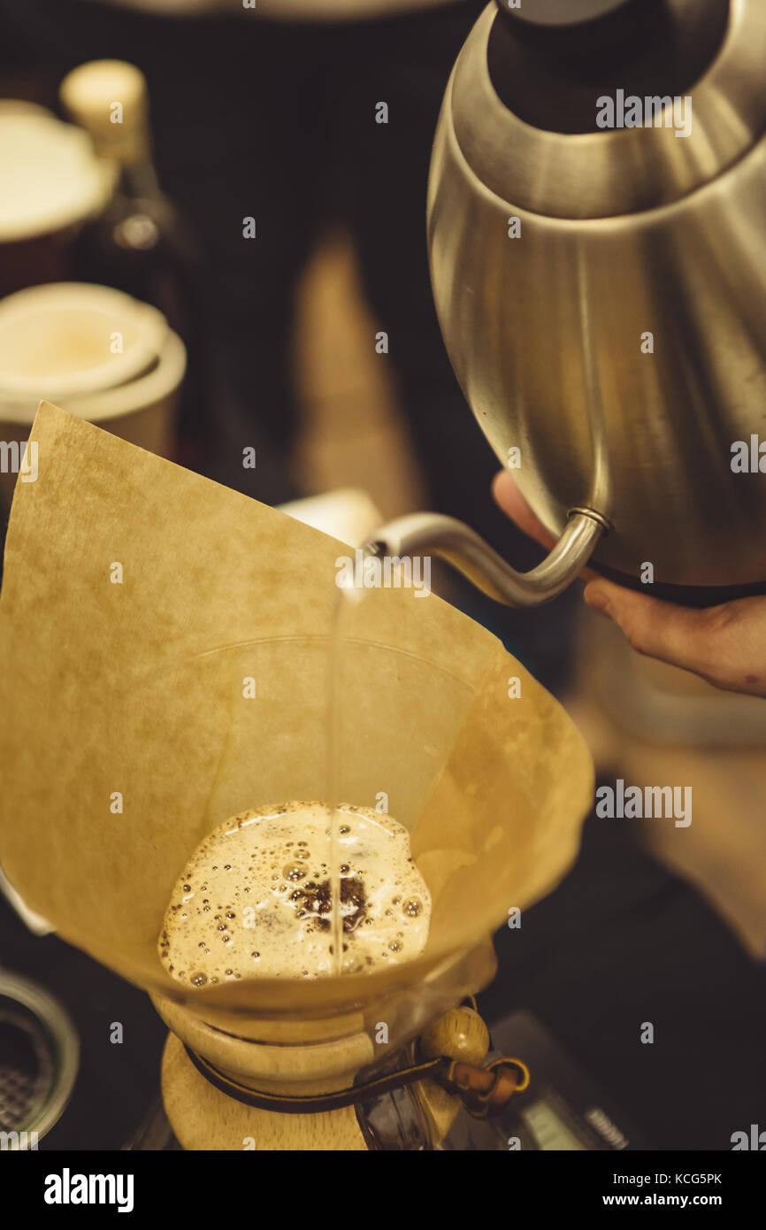 Barista pouring water to coffee Stock Photo - Alamy