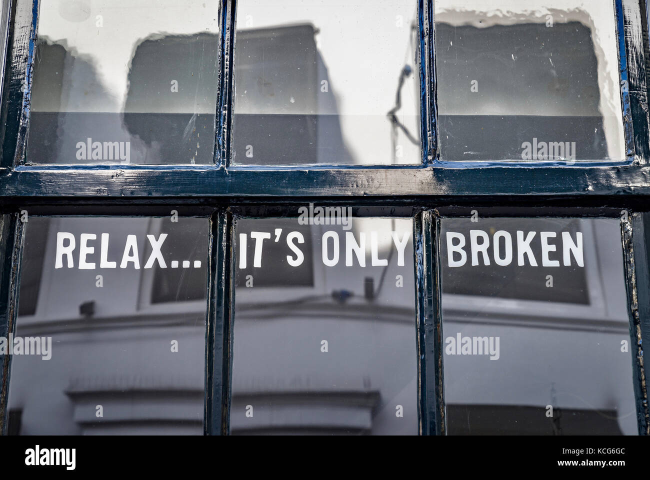 Window showing the message: Relax.... It's only broken Stock Photo - Alamy