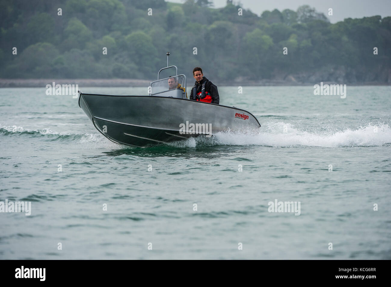 An aluminium speed boat with two male occupants on the sea off the ...