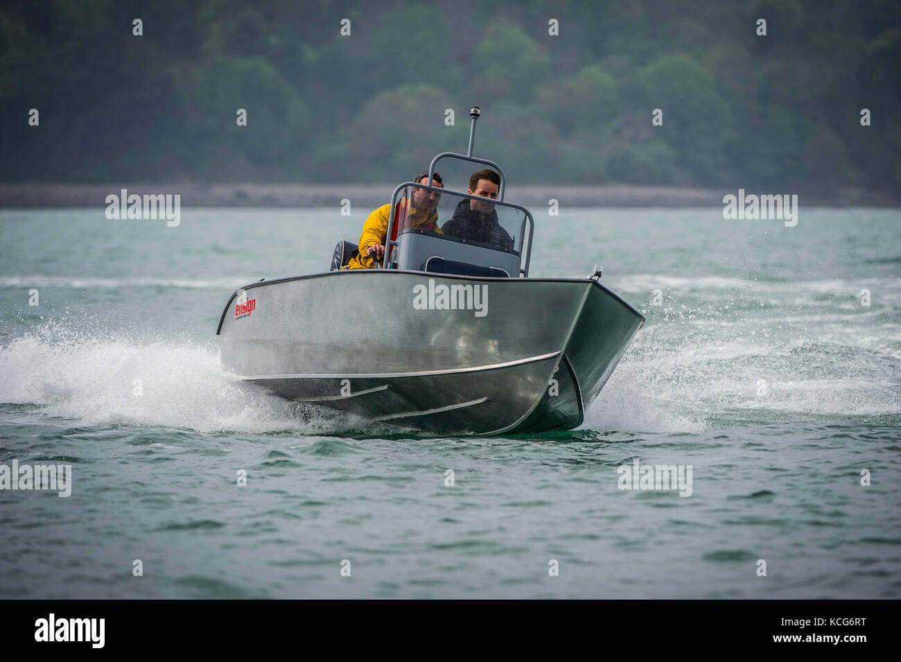 An aluminium speed boat with two male occupants on the sea off the ...