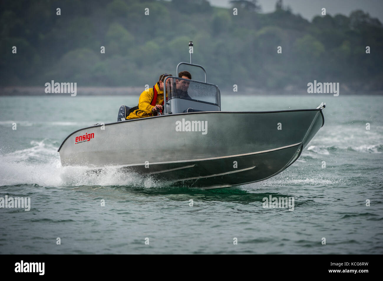 An aluminium speed boat with two male occupants on the sea off the ...