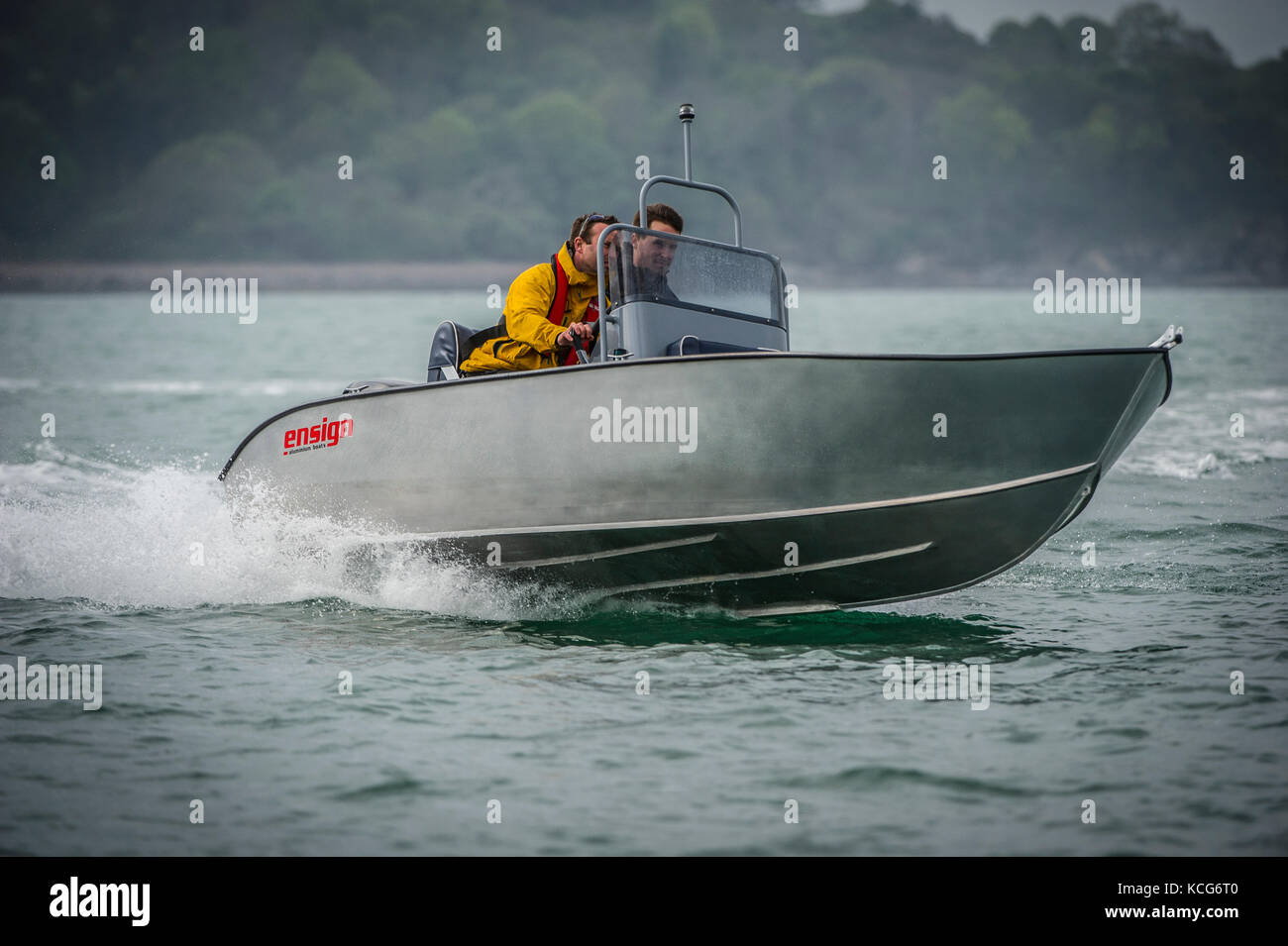 An aluminium speed boat with two male occupants on the sea off the ...