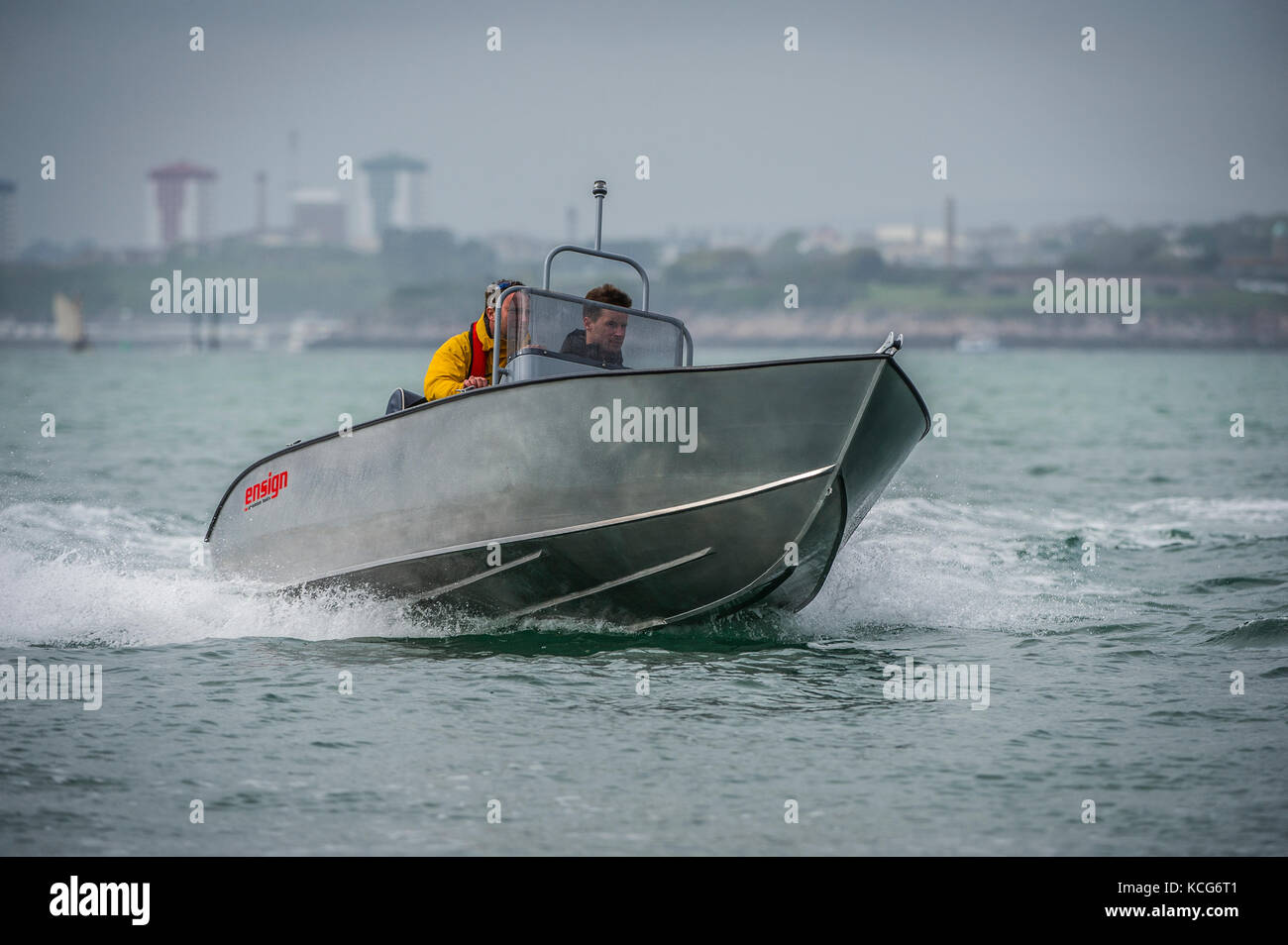 An aluminium speed boat with two male occupants on the sea off the ...