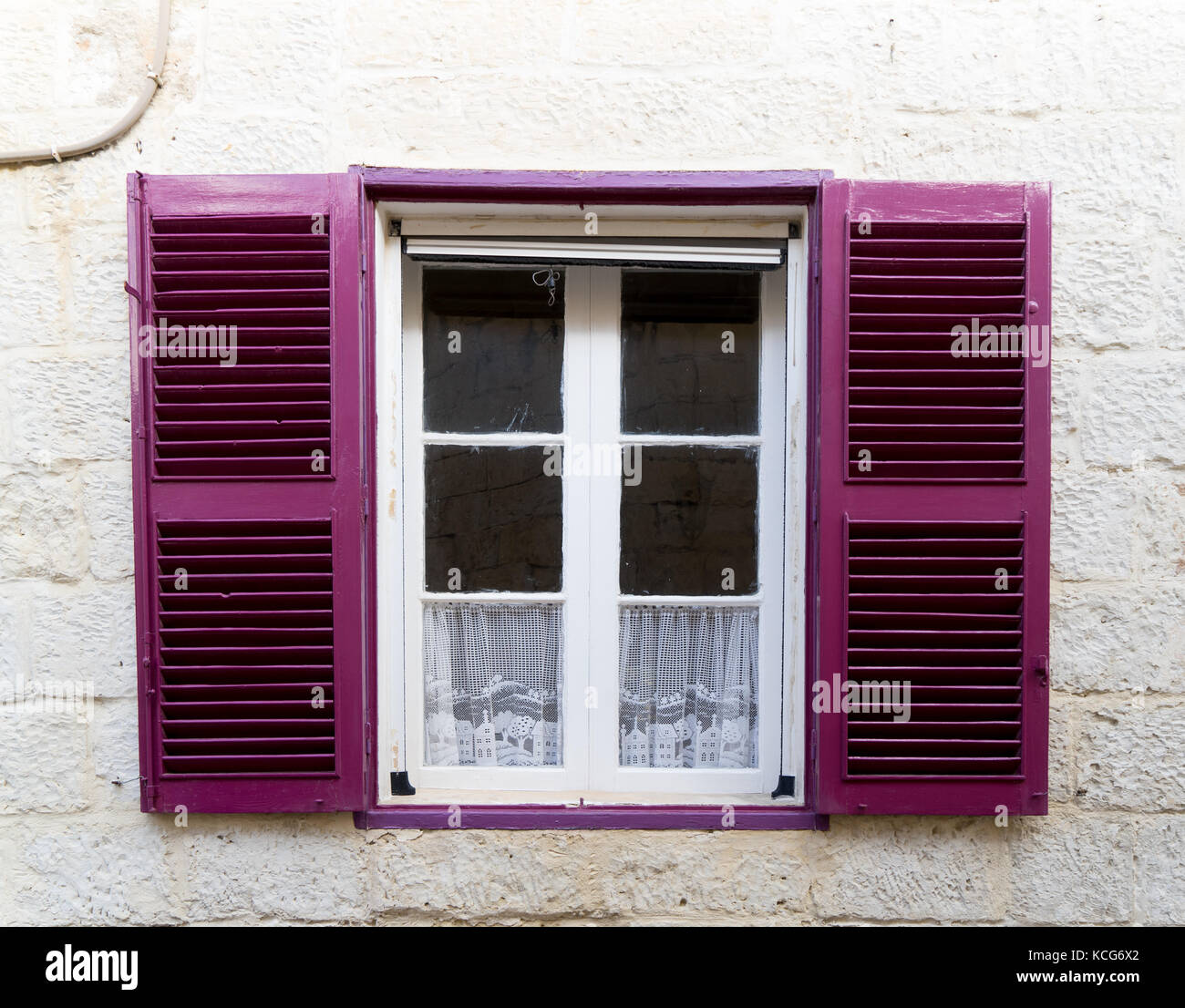 Small window with purple shutters Stock Photo - Alamy