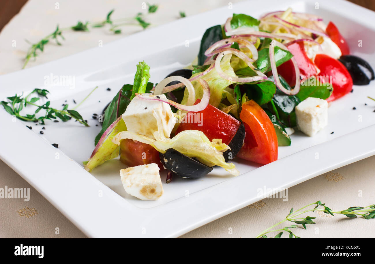 Fresh Greek salad on square plate Stock Photo - Alamy
