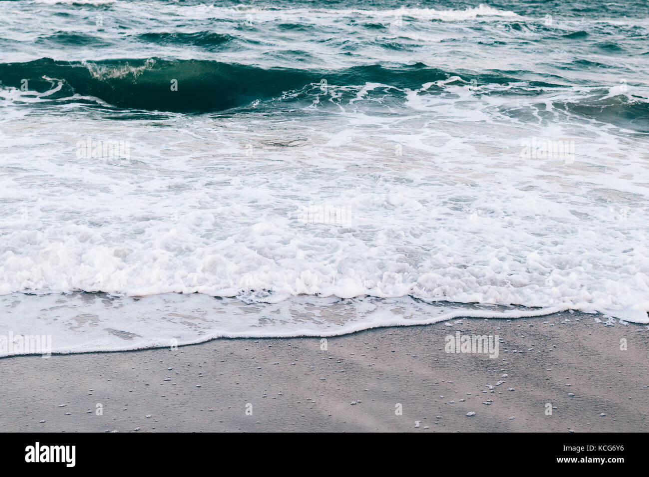 Sea waves rolled on a beach sand, close-up Stock Photo - Alamy
