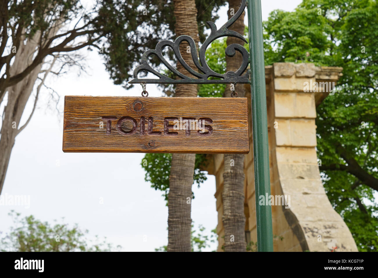Sign of toilet written on a wooden board. Mark public toilet in the ...