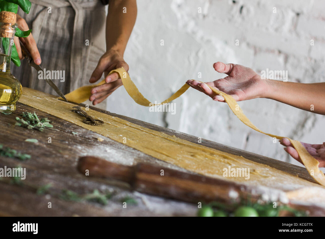 Man and woman makingg homemade pasta together Stock Photo - Alamy