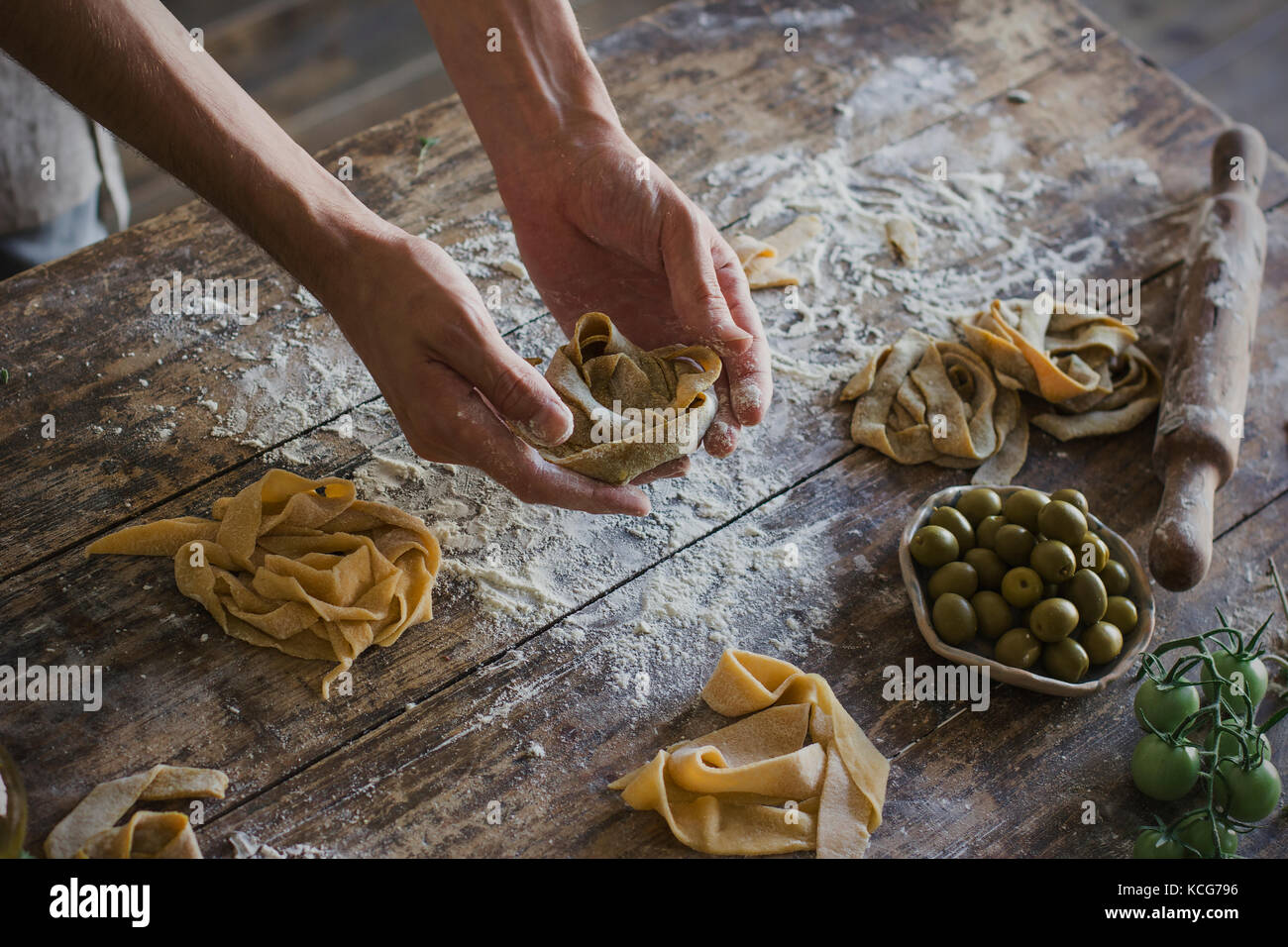 The young man in apron making homemade pasta Stock Photo - Alamy
